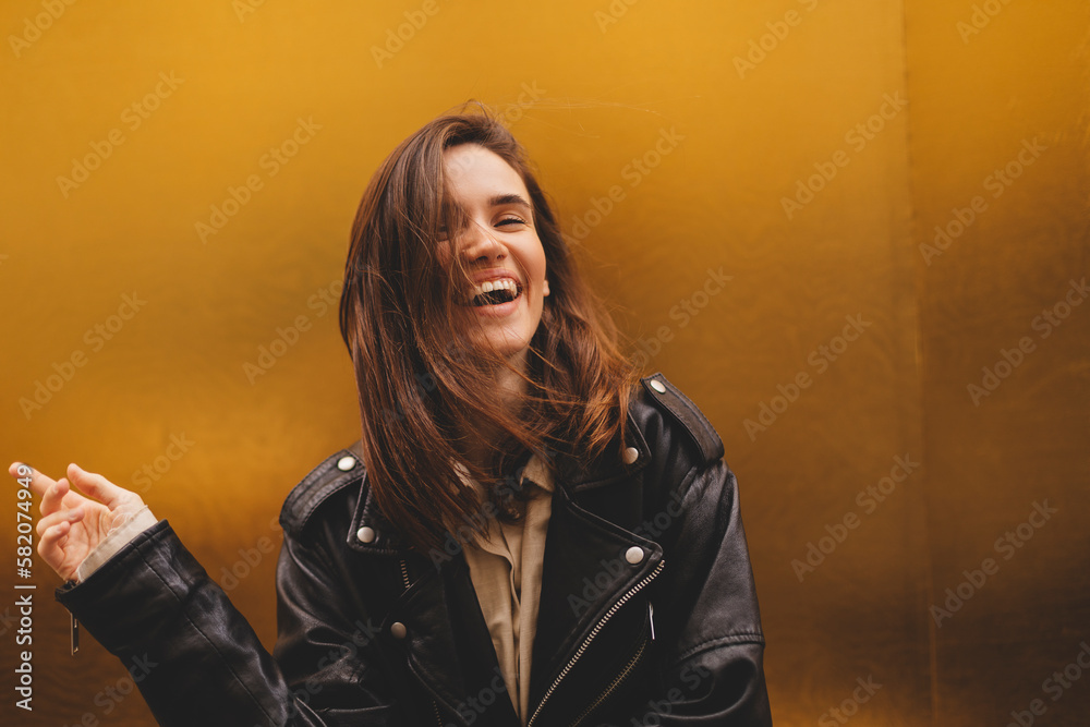 Simpering young brunette woman with a coy smile as she flirts over a ...