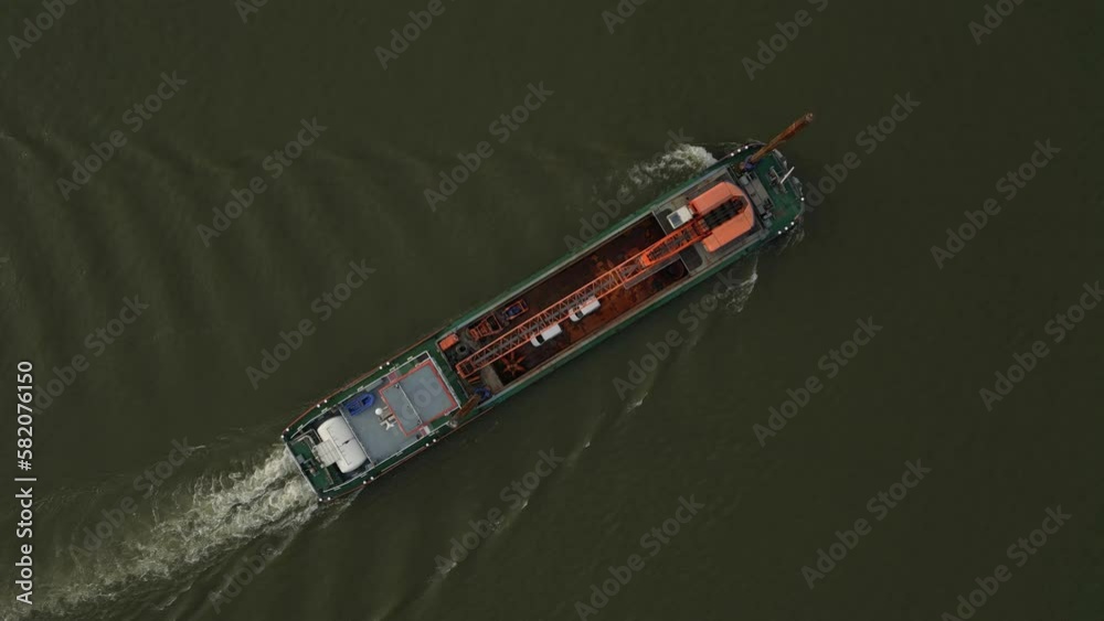 Aerial topdown view of vessel ship with crane floating on water in ...