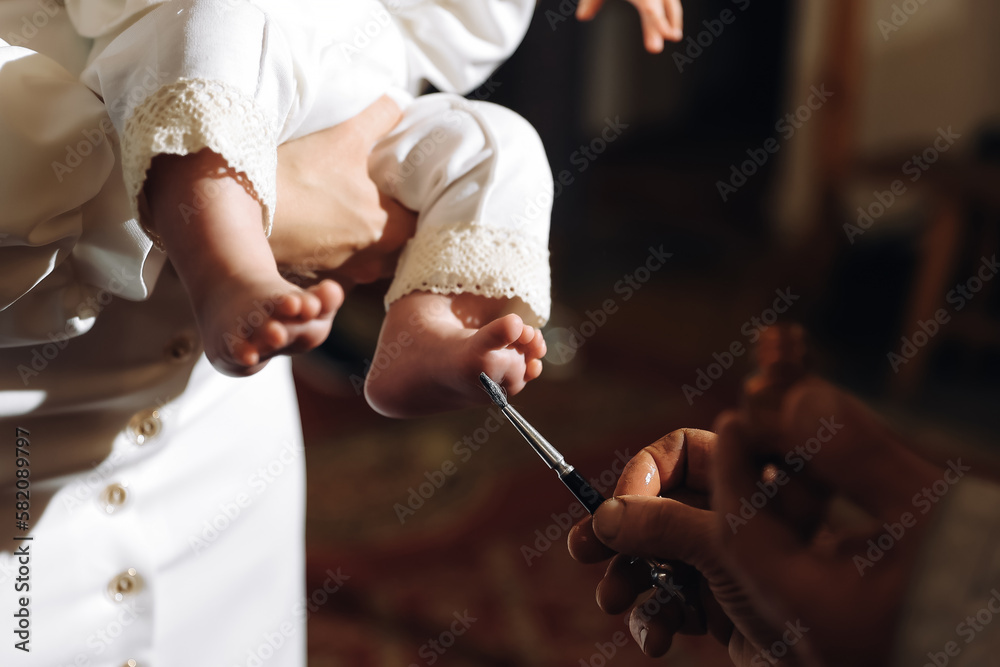 The sacrament of baptism. Newborn baby during christening and ...