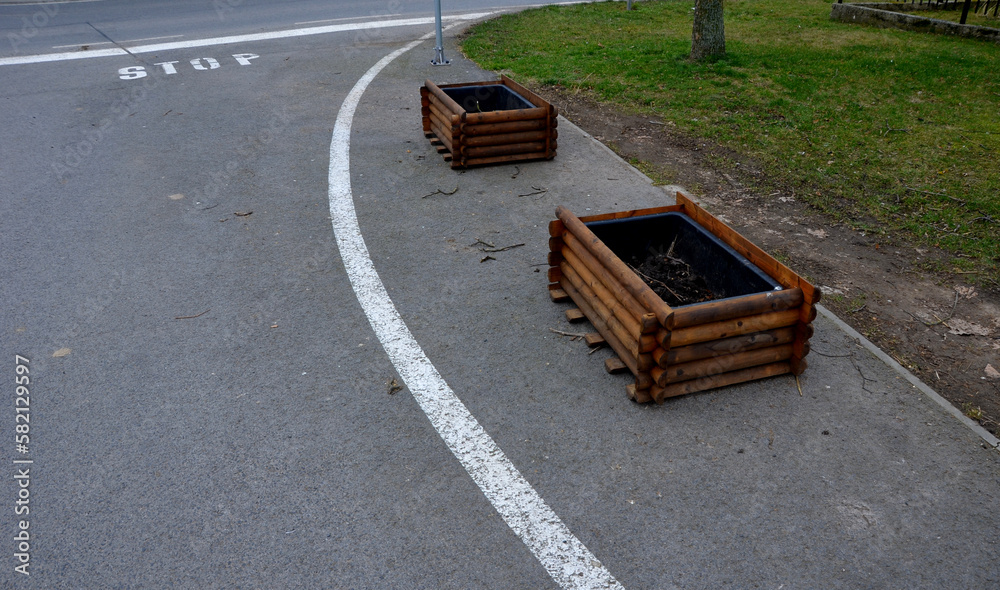 ornamental flower pots next to the road in the square. annual flowers ...