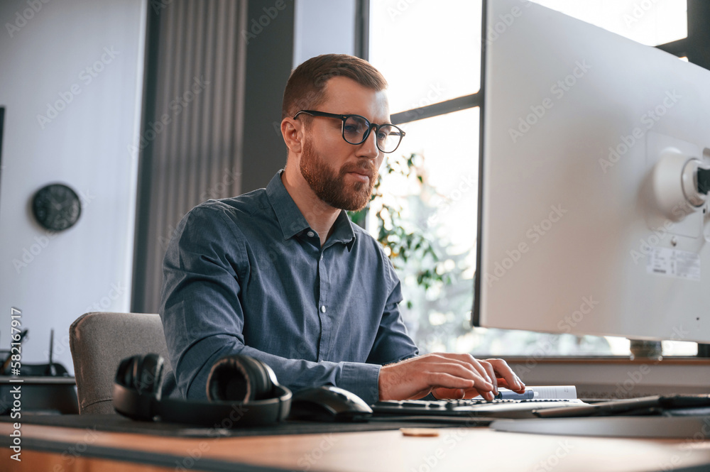 Typing on the keyboard. Man in formal clothes is working in the modern ...