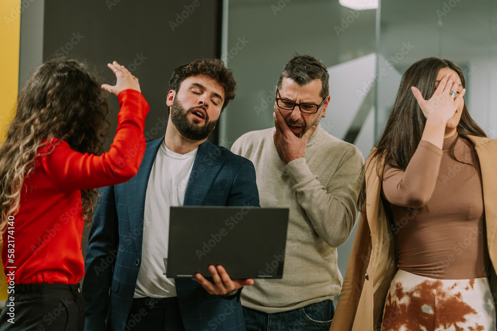 Four disappointed business people reacting to their client declining ...