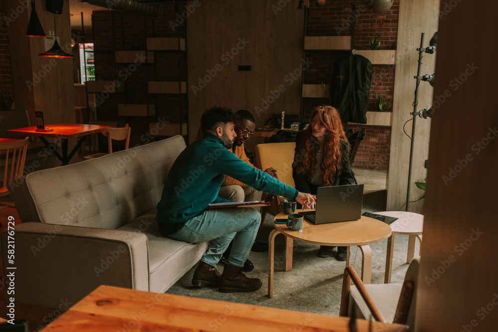 Good looking businessman pointing at the lap top and talking business ...