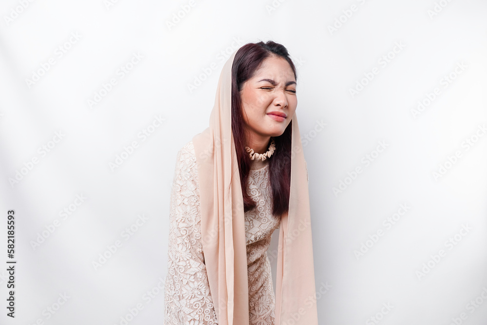 Tired upset young Asian Muslim woman wears headscarf suffering from ...