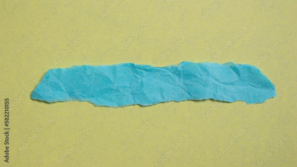 Creased blue paper piece on a yellow background. Crumpled torn paper ...
