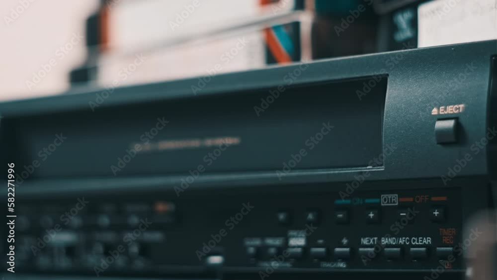 Insert VHS cassette into VCR player. Black vintage videotape cassette ...