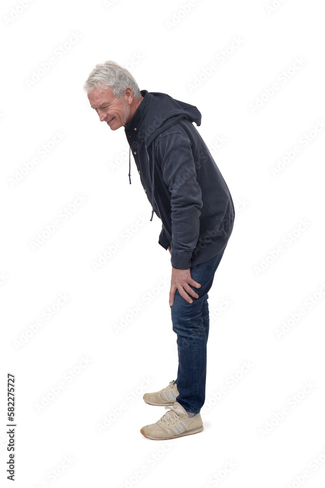 full portrait of side view of a man crouched down and looking the floor ...