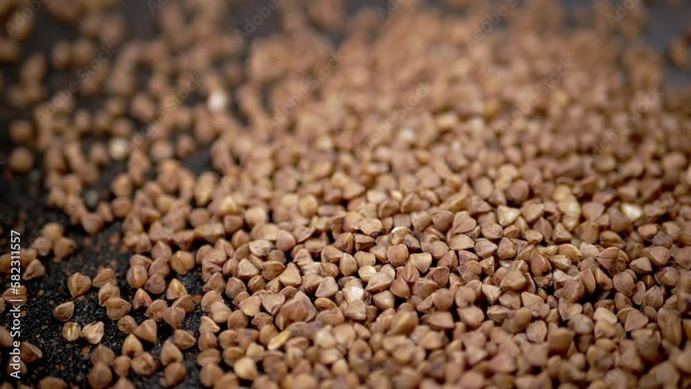 Grains of Buckwheat Fall on a Black Background in Slow Motion. Close up ...