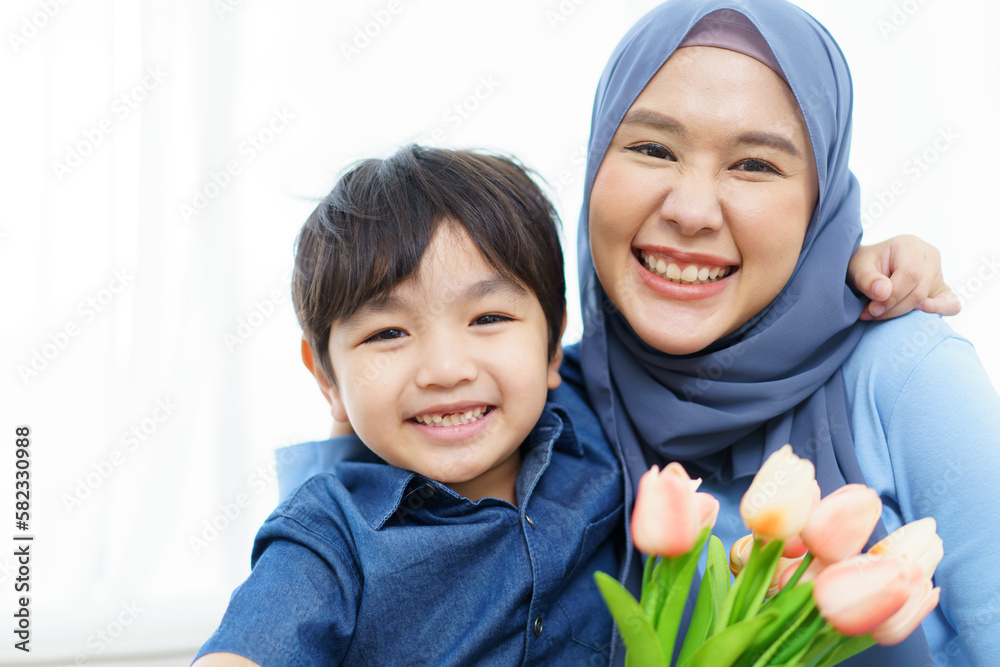 Happy cheerful Asian muslim family living together in a weekend, woman ...