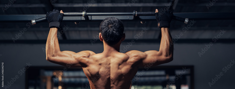 Athletic pulling up showing back muscle at gym. Muscular man exercise ...