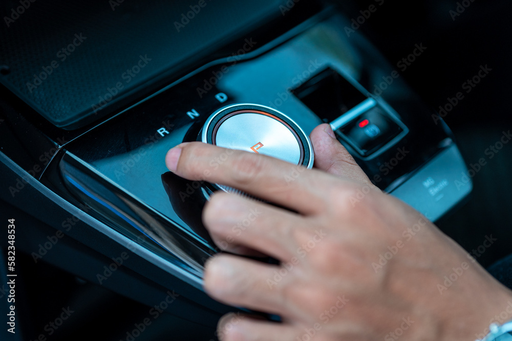 Men's hand crank controls the electric car driver shifting gears ...