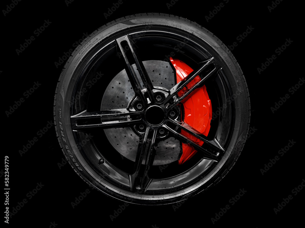 Car alloy wheel and tyre isolated on black background. New alloy wheel ...