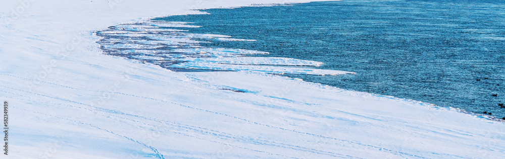 Melting ice on the river, the sharp edge of the ice borders on running ...