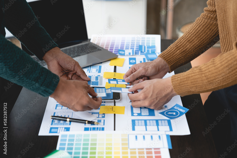 ux developers and ui designers, data researchers brainstorm on tabletop ...