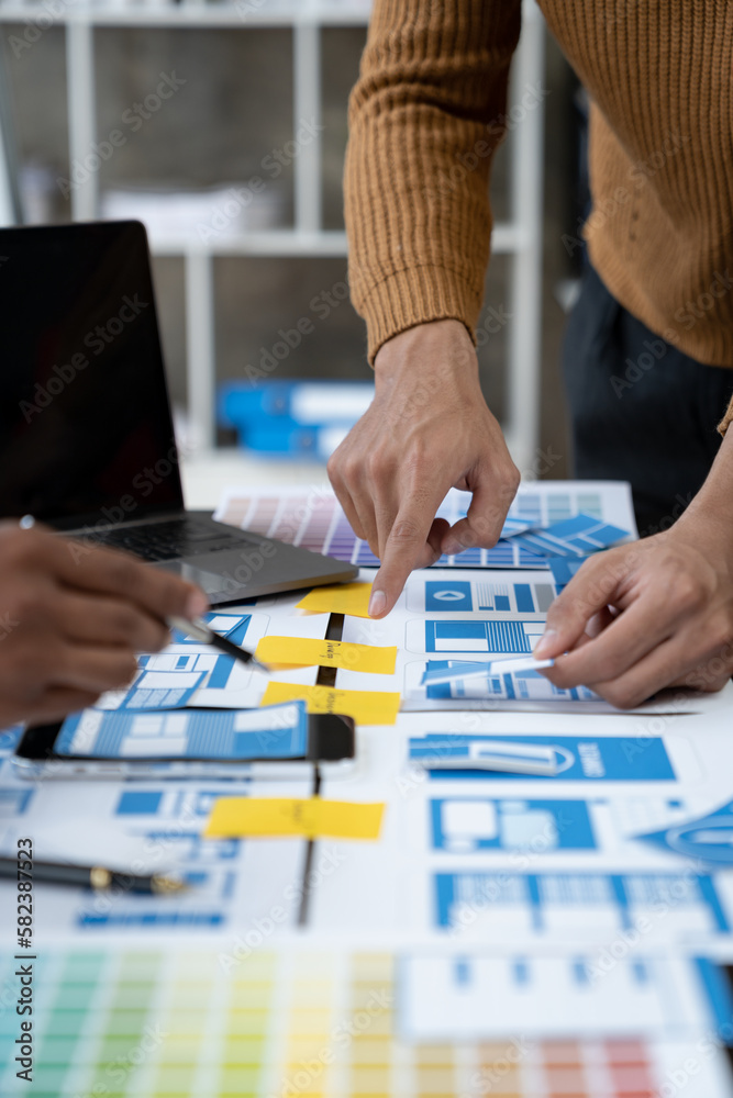 ux developers and ui designers, data researchers brainstorm on tabletop ...