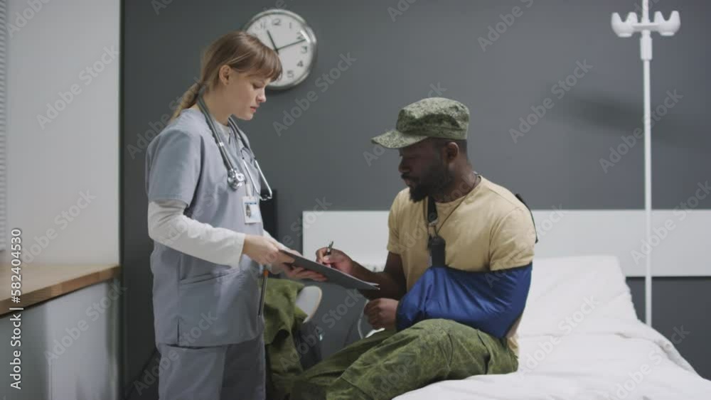 African American soldier wearing arm sling getting discharged from ...