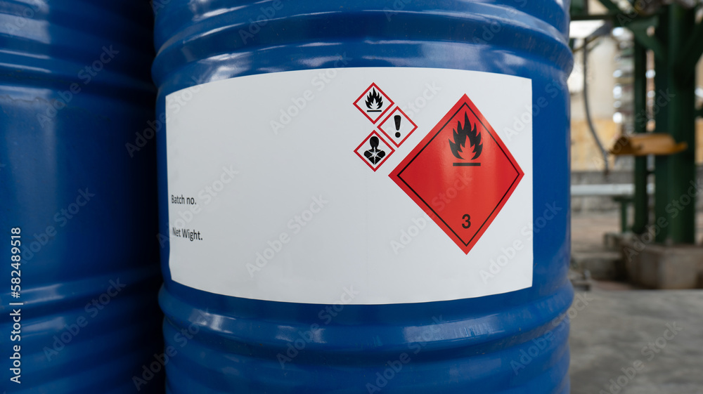 A 200 liter drum mounted with a chemical hazard warning label displays ...