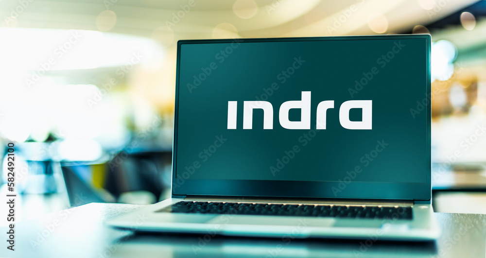 Laptop computer displaying logo of Indra Sistemas Stock Photo | Adobe Stock