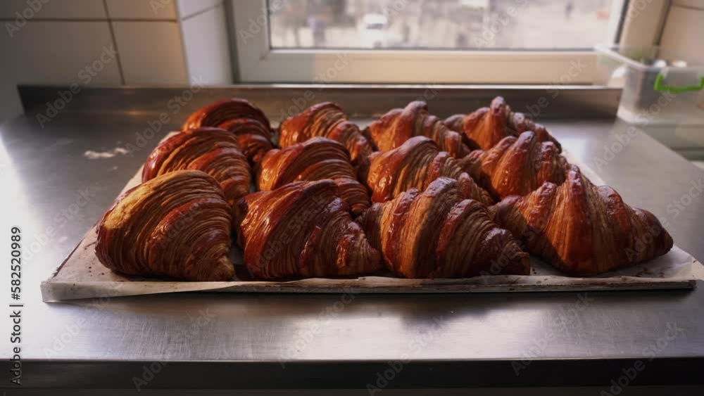 Croissants are in tray after leaving the oven for customers on ...