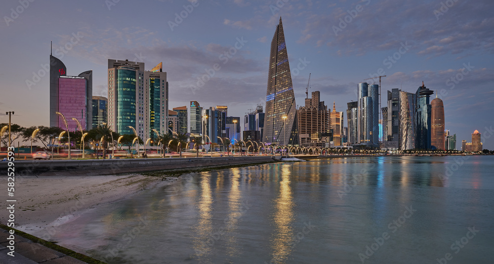 Doha Qatar skyline from corniche promenade at dusk showing West Bay ...