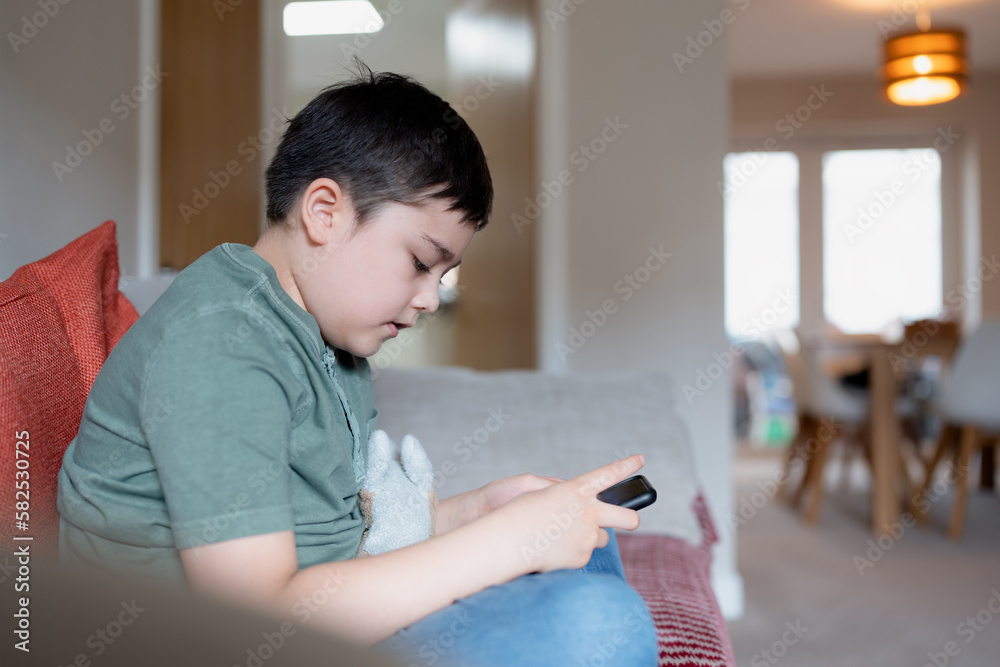 Kid using mobile phones typing text message,School Boy using cell phone ...