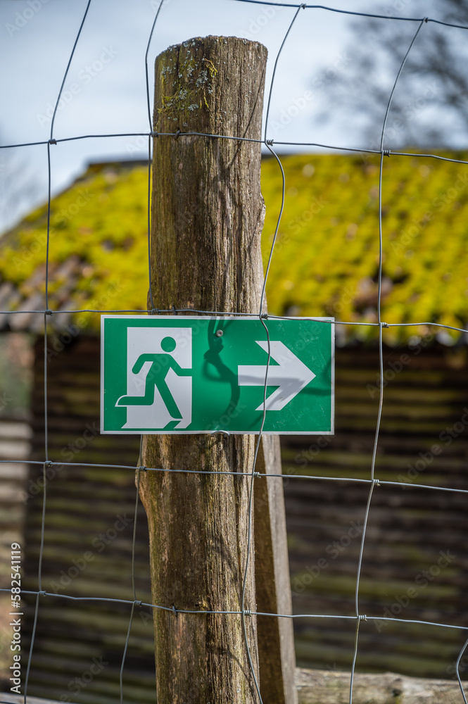 Green Emergency Exit Sign at a Wildlife Park, Amusement Park hanging on ...