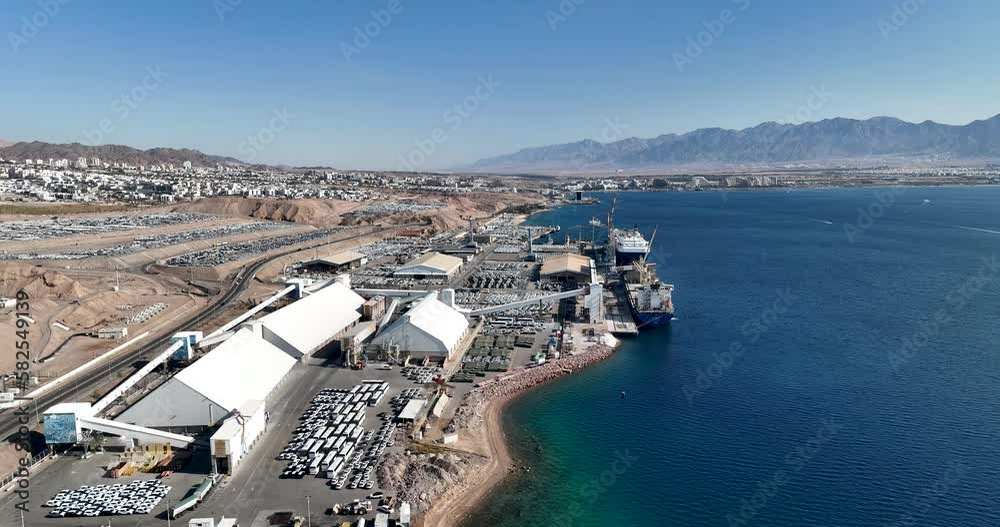 Aerial footage of Eilat sea port in the red sea. Cargo ships anchor in ...