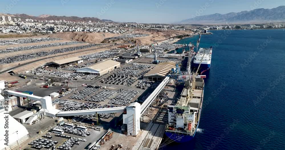 Aerial footage of Eilat sea port in the red sea. Cargo ships anchor in ...