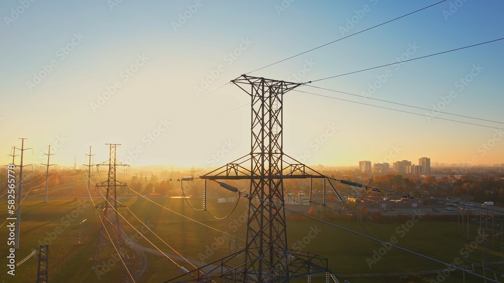High voltage electricity pylon at golden hour background. International ...