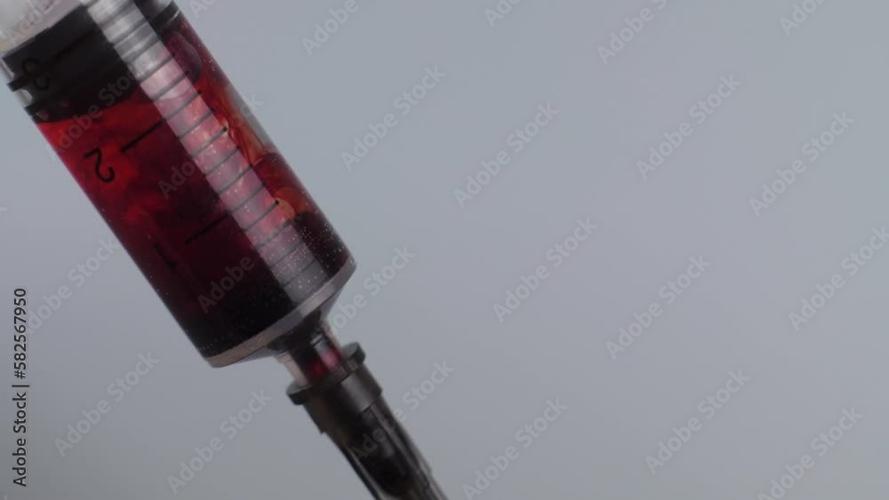 Extreme close-up drawing in blood into syringe. Macro shot medical ...