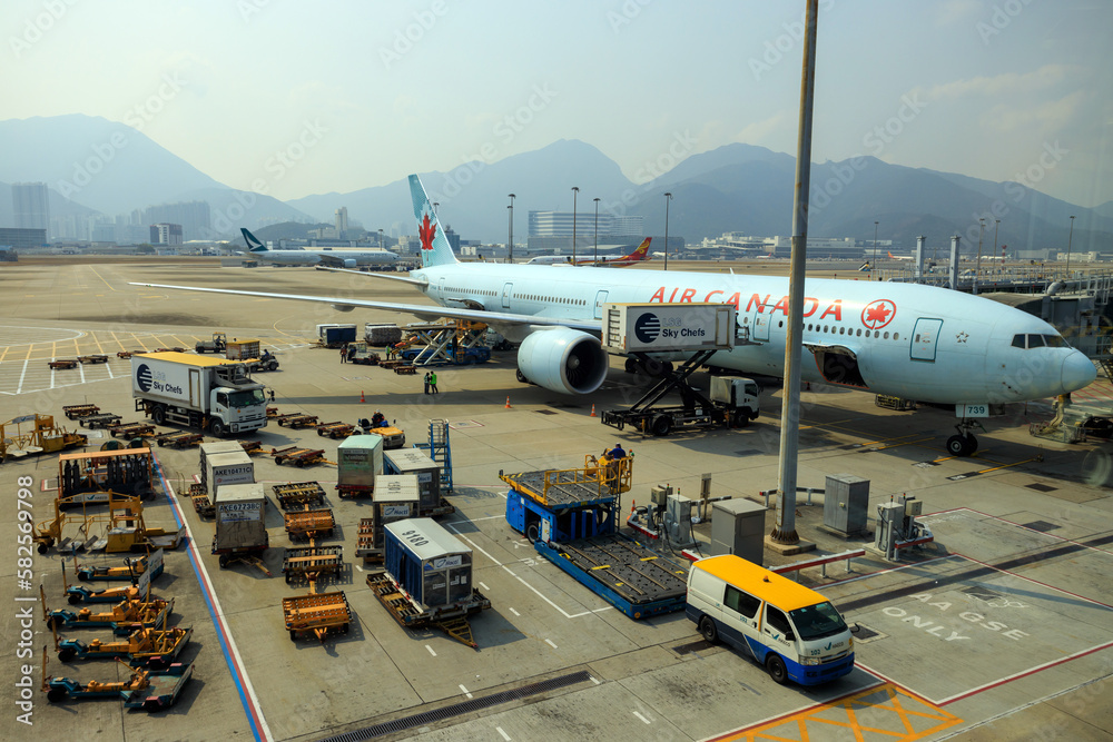 Hong Kong - March 1, 2023: Airplane at boarding gate jet bridge in Hong ... Hong Kong - March 1, 2023: Airplane at boarding gate jet bridge in Hong ...