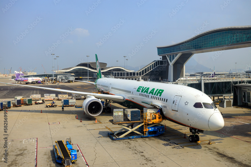 Hong Kong - March 1, 2023: Airplane at boarding gate jet bridge in Hong ... Hong Kong - March 1, 2023: Airplane at boarding gate jet bridge in Hong ...