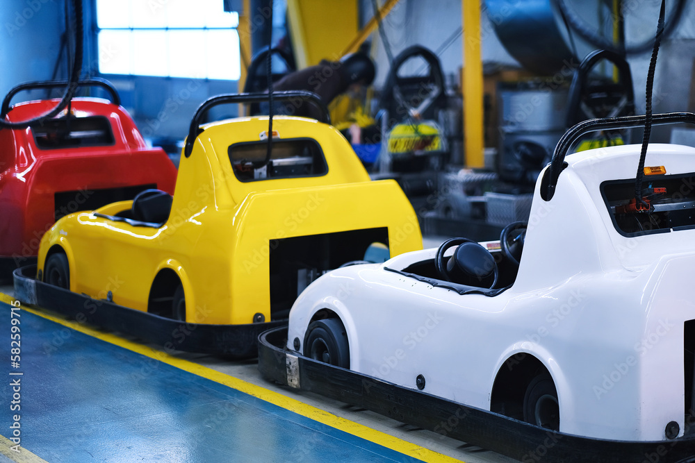 Red, yellow and white empty go karts in a row and getting ready to ...