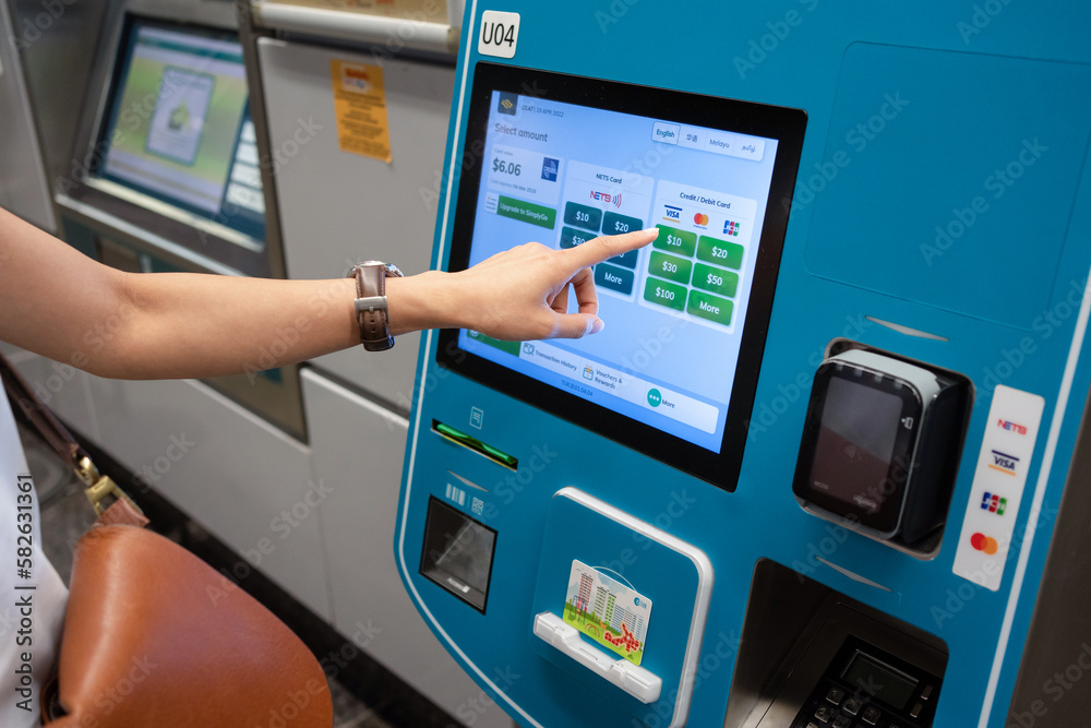 Foto de SINGAPORE - APR 19, 2022: Lady's hand select the amount to be ...