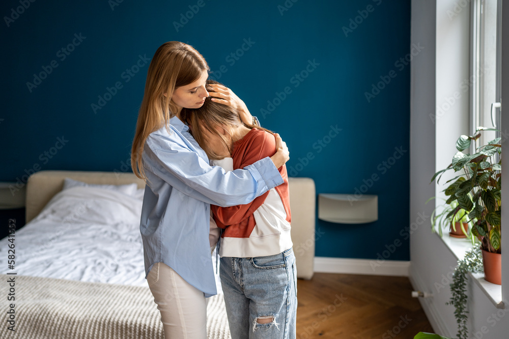 Loving caring mother hugging teen daughter. Parent mom showing understanding and support to ...