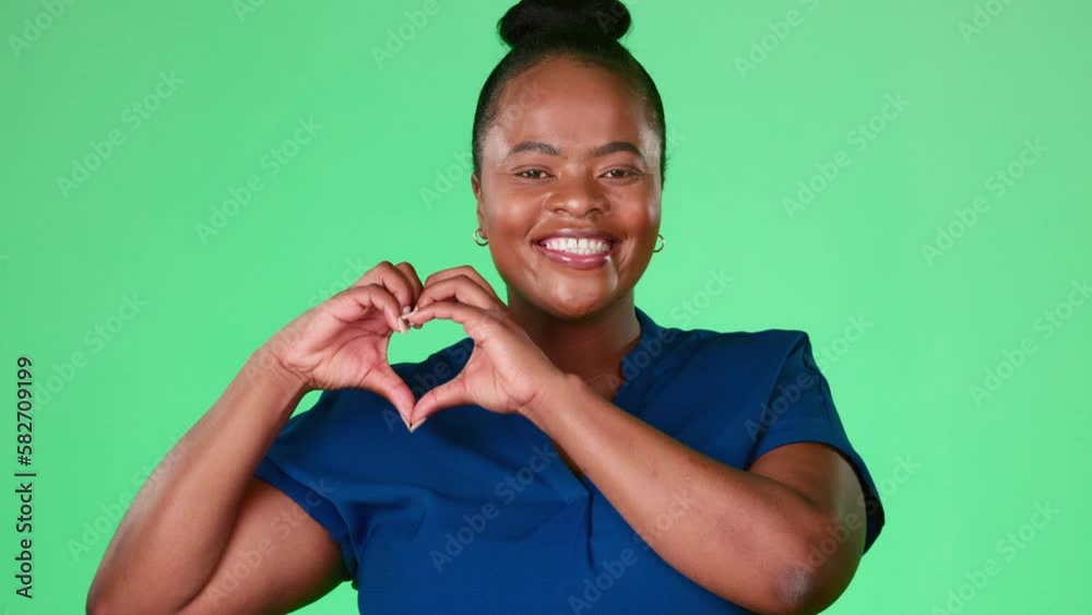 Black woman with heart hands isolated on studio background or green ...