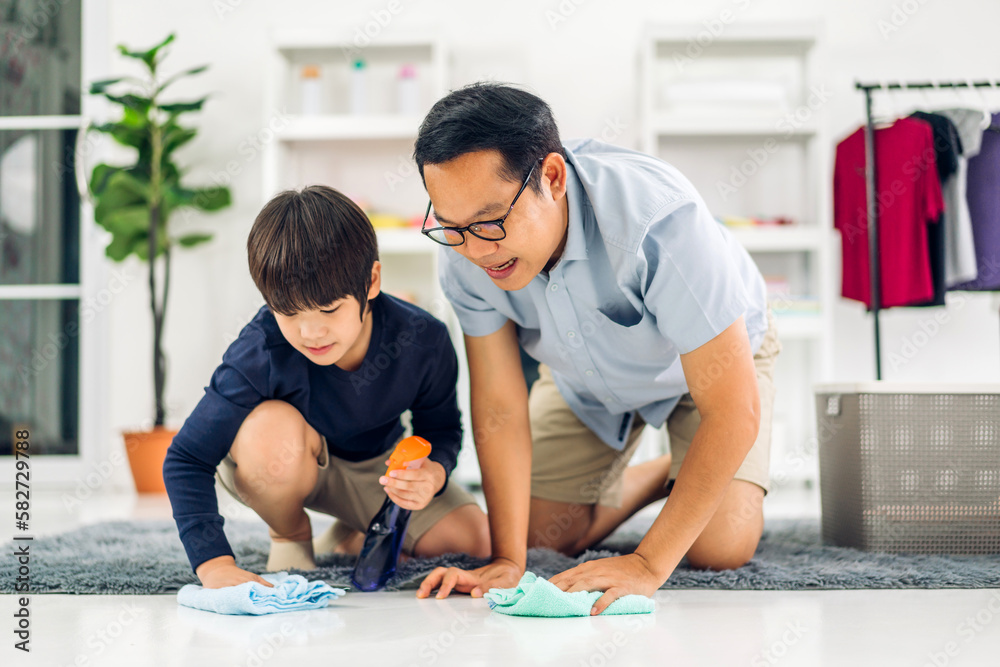 Father teaching asian kid little boy son use disinfectant spray bottle ...