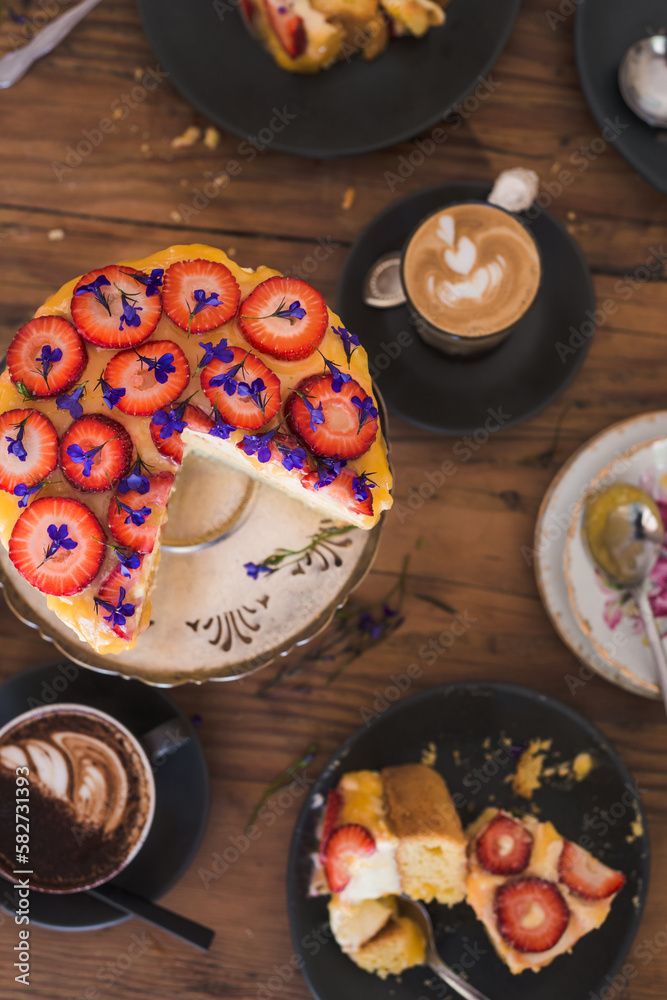 sponge cake with lemon curd, strawberries and edible flowers, half ...