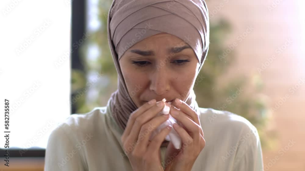 Close up portrait of young sick middle eastern lady in hijab suffering ...