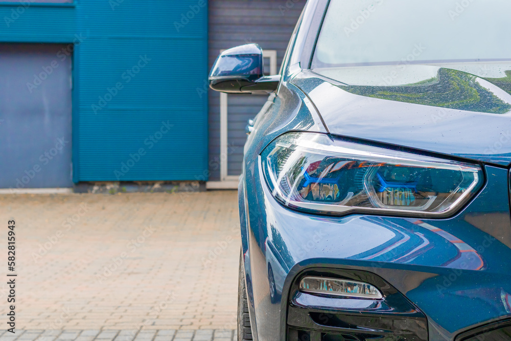 Close up detail blue modern car headlights with led technology on city ...