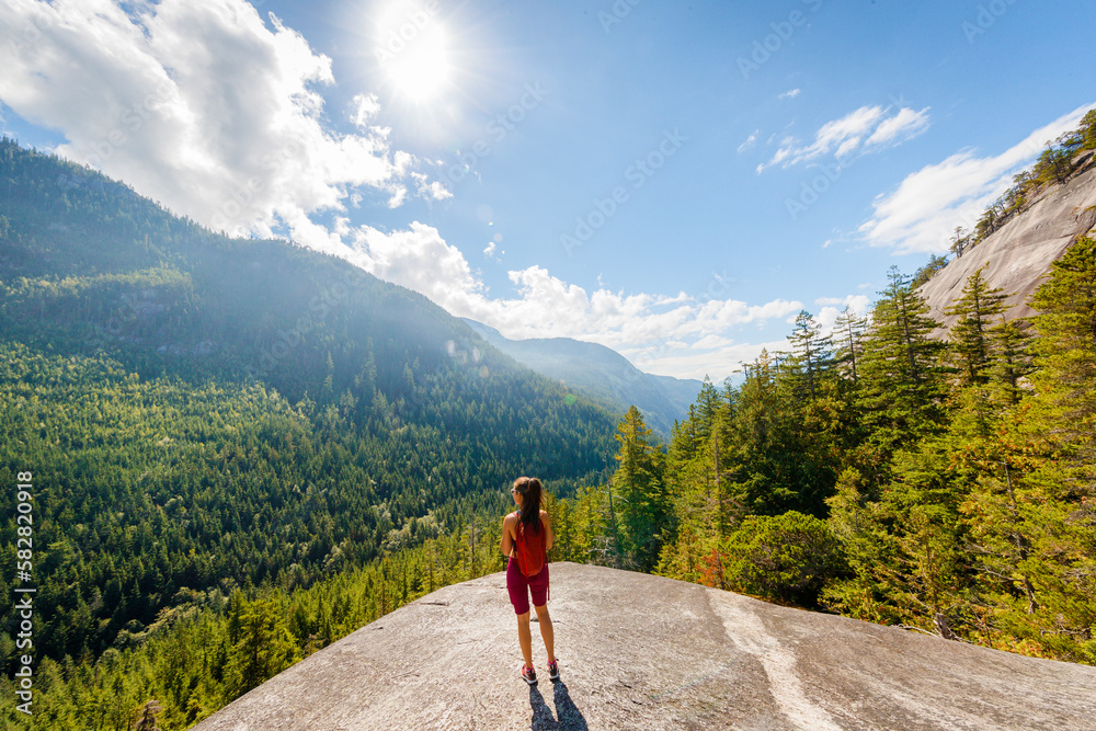 Hiking woman reaching amazing viewpoint on famous Squamish Stawamus ...