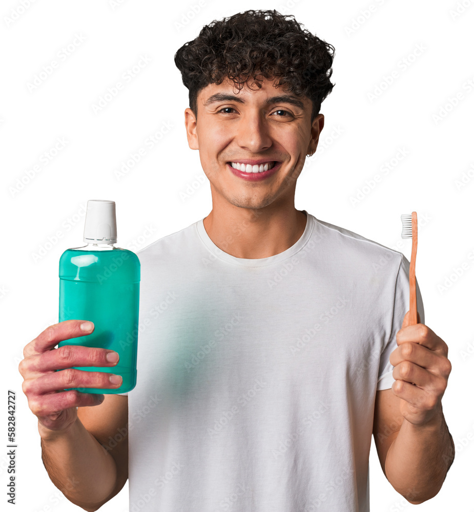 A young man promotes daily dental hygiene, holding a toothbrush and ...