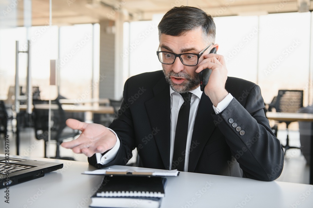 Experienced executive manager quarreling with employee on mobile ...