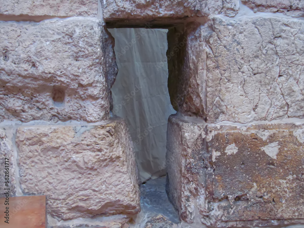 Eye of a needle a gate in Jerusalem. Bible story: Matthew 19,16-24 ...