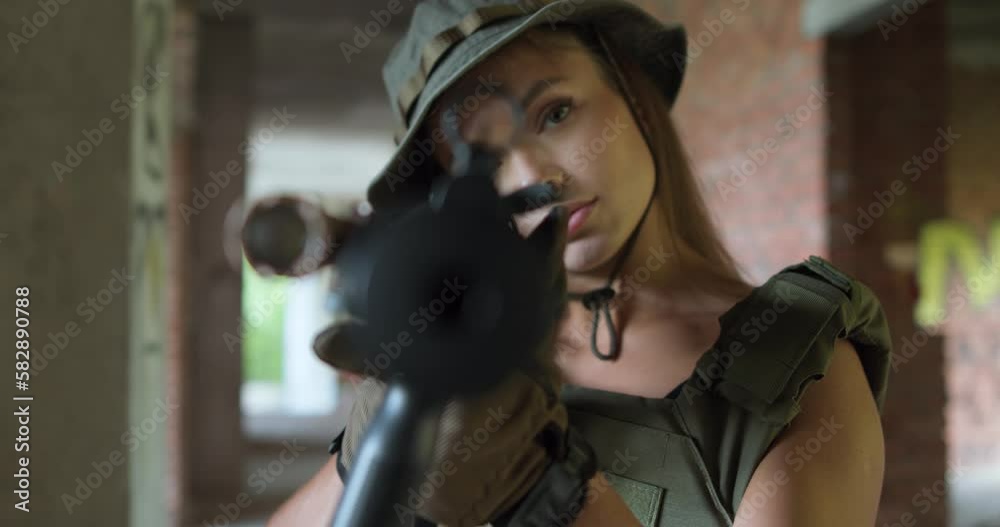 serious confident beautiful female soldier holding sniper rifle ...