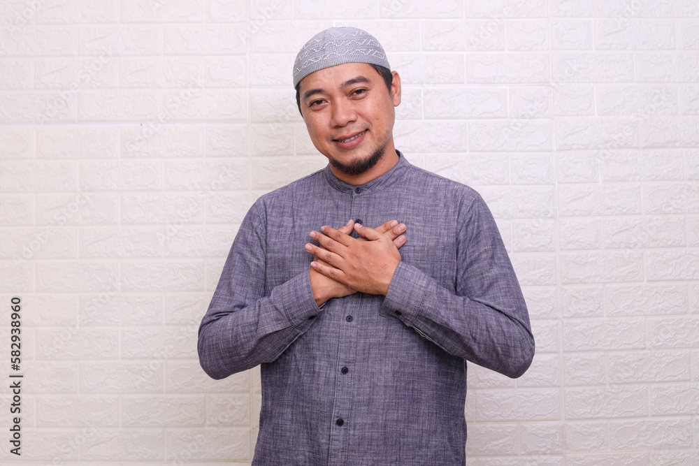 Grateful muslim man keeping both hands on chest, expressing gratitude ...