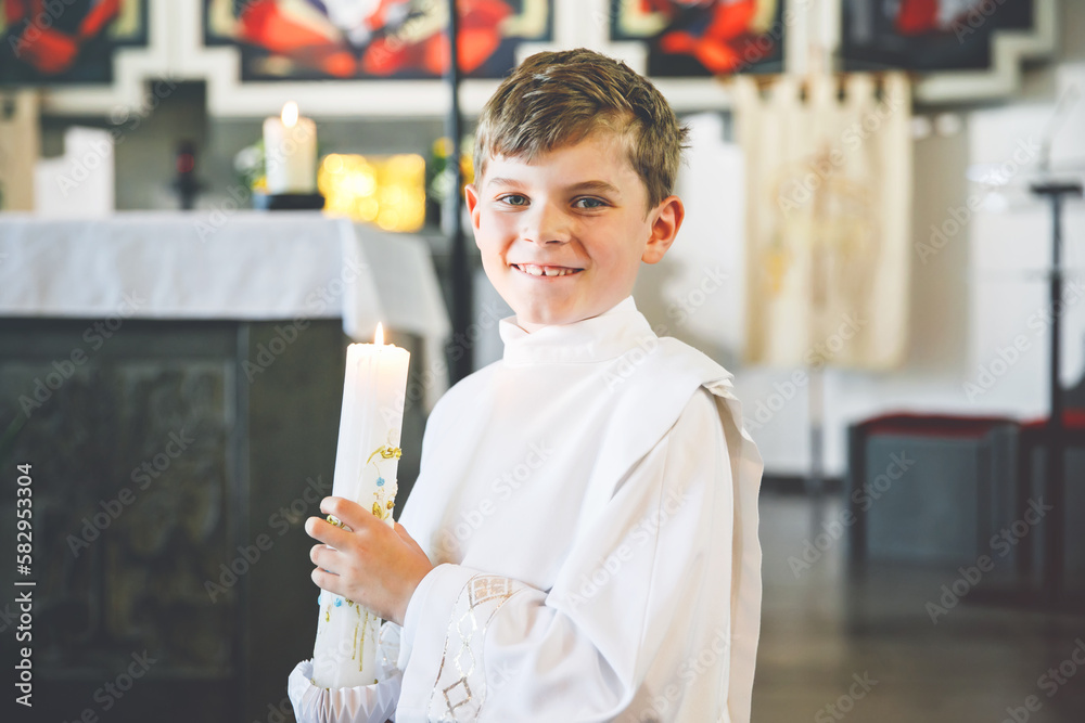 Little kid boy receiving his first holy communion. Happy child holding ...