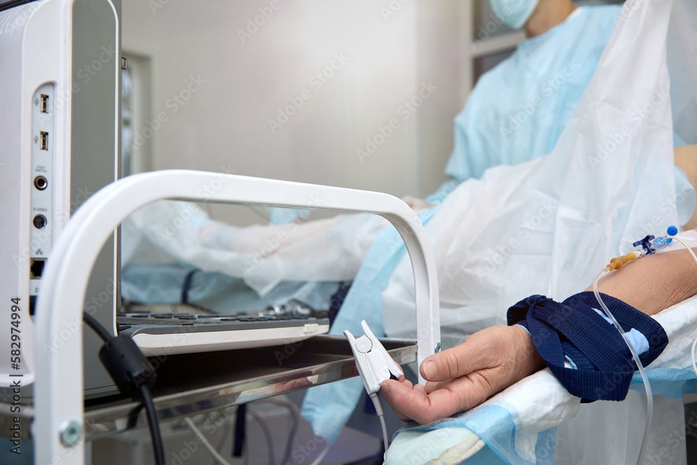 Foto de Patient's hand is tied motionless to operating table for ...