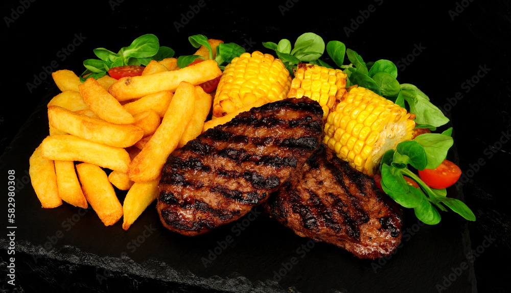Beef grill steak and chips meal with sweetcorn cobs and lambs leaf ...
