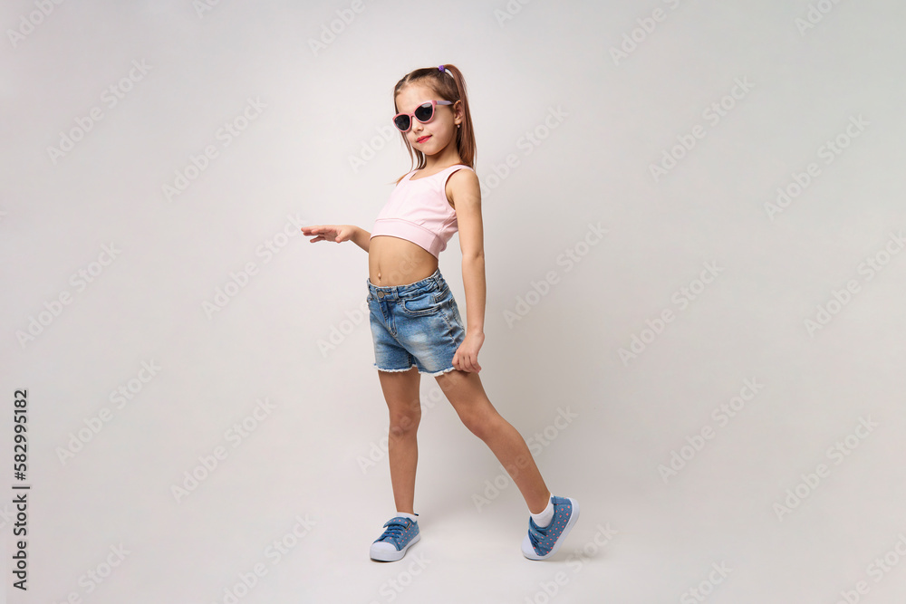 Cute little girl wearing denim shorts and top, white background Stock ...
